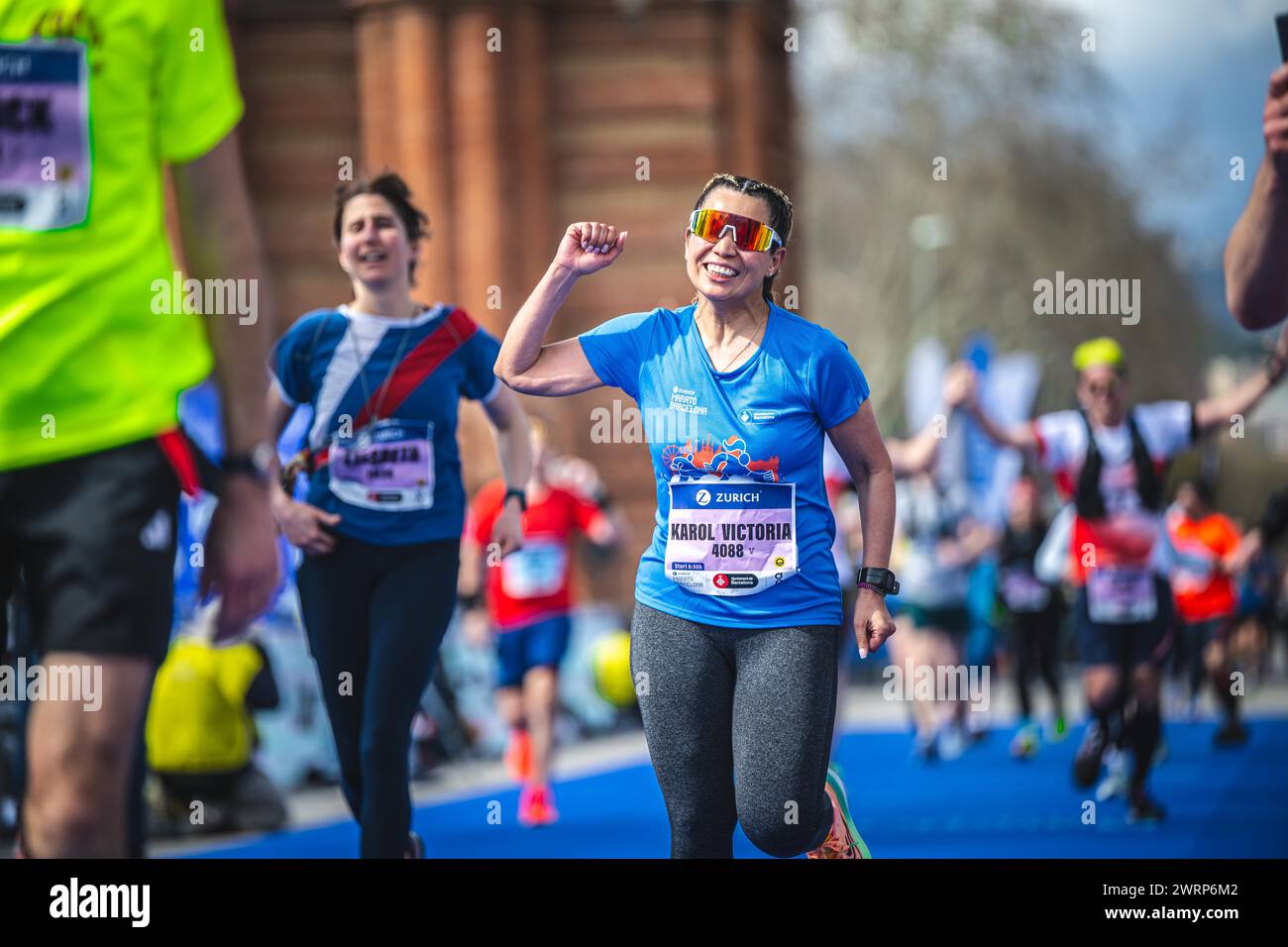 Runners happily reaching the finish line in the Barcelona Marathon in ...