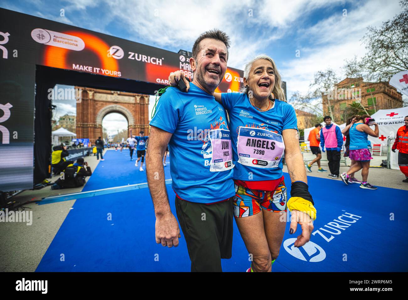 Runners happily reaching the finish line in the Barcelona Marathon in ...