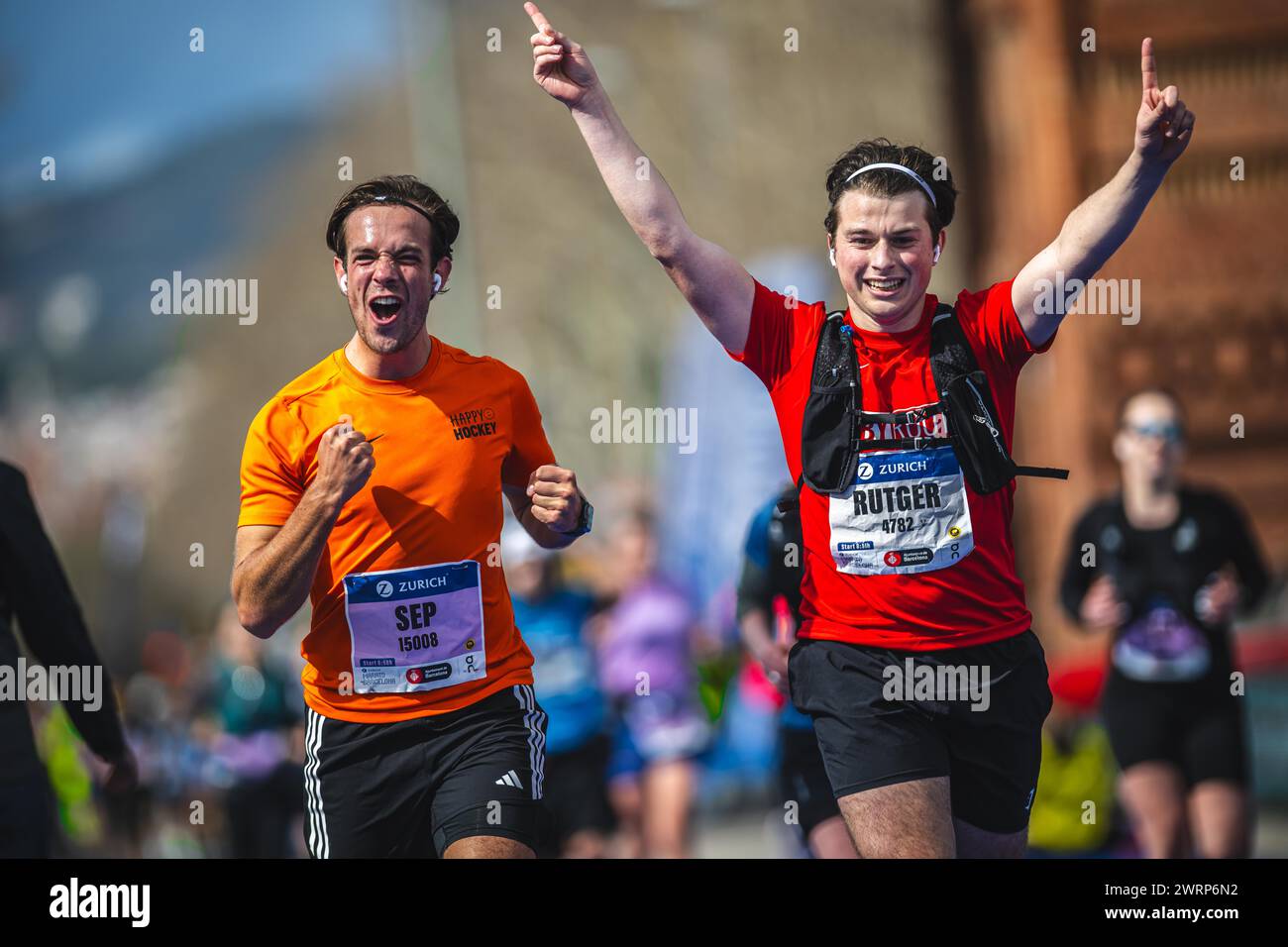 Runners happily reaching the finish line in the Barcelona Marathon in ...