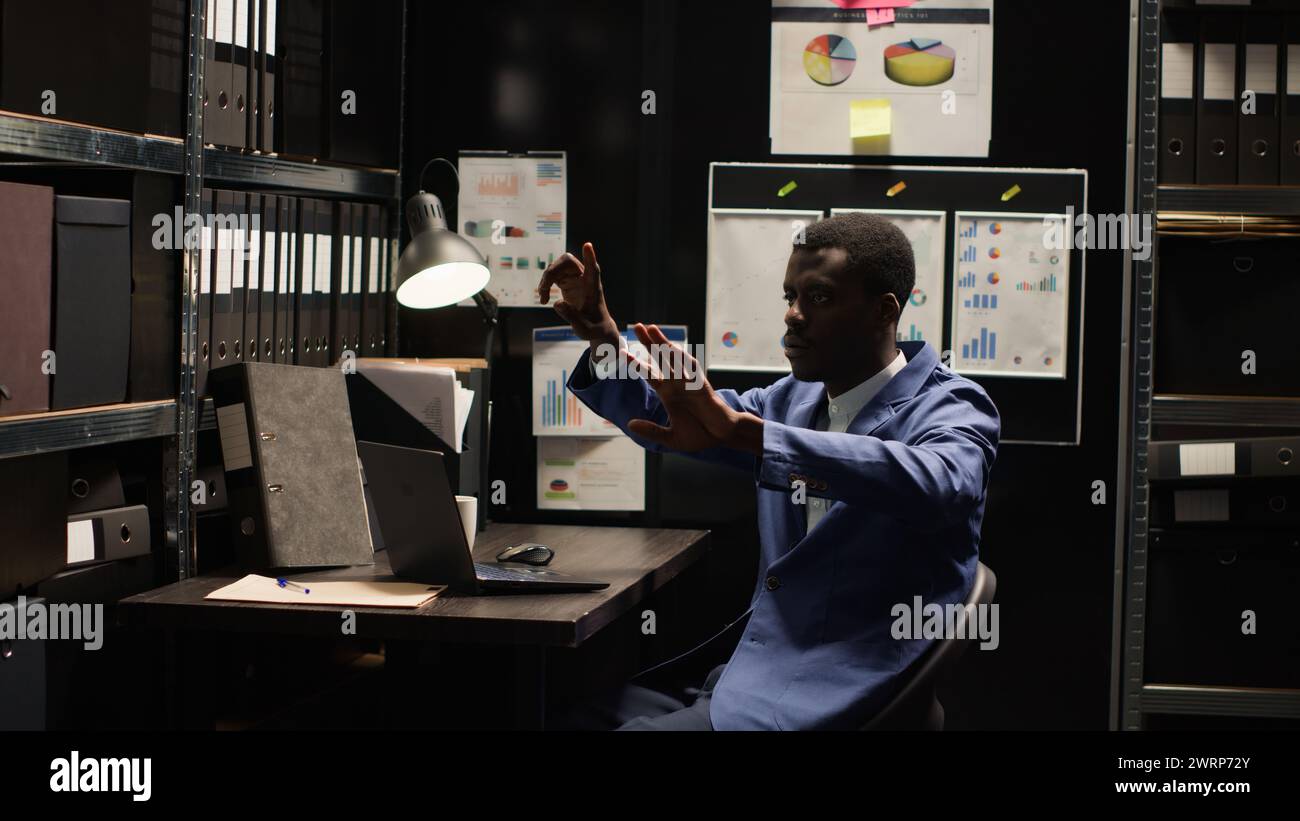 Black policeman investigates complex case, surrounded by evidence ...