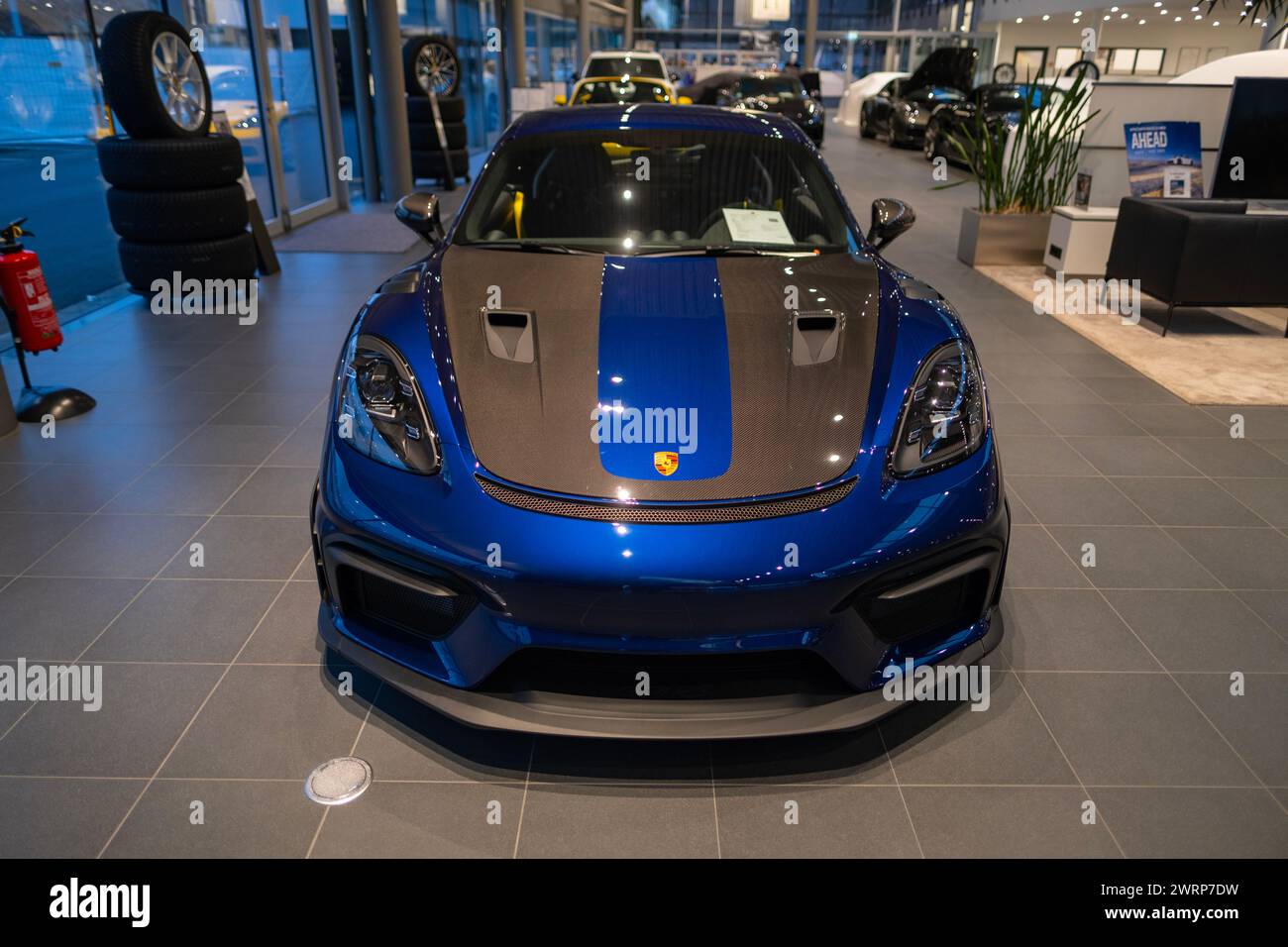 powerful blue-grey Porsche 718 Cayman GT4 RS racing car parked in ...
