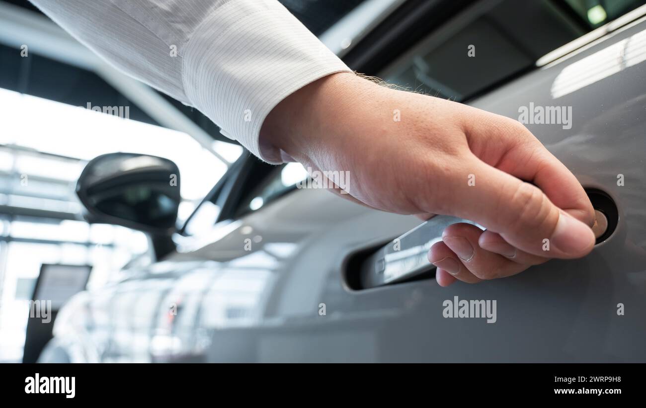 A man opens a car door with a fingerprint. Integrated handle Stock ...