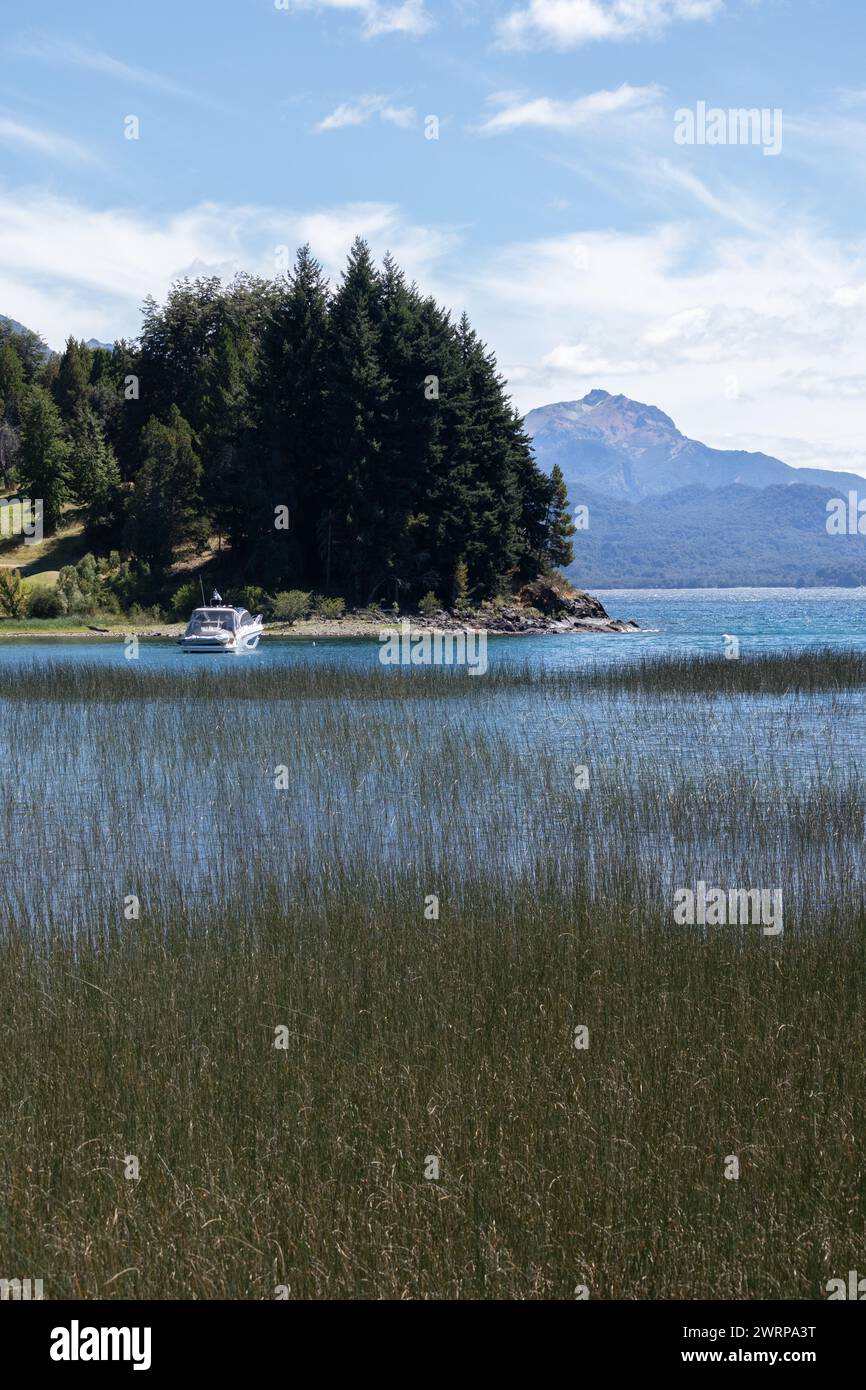 Vertical view of blue lake with a boat floating in it Stock Photo - Alamy