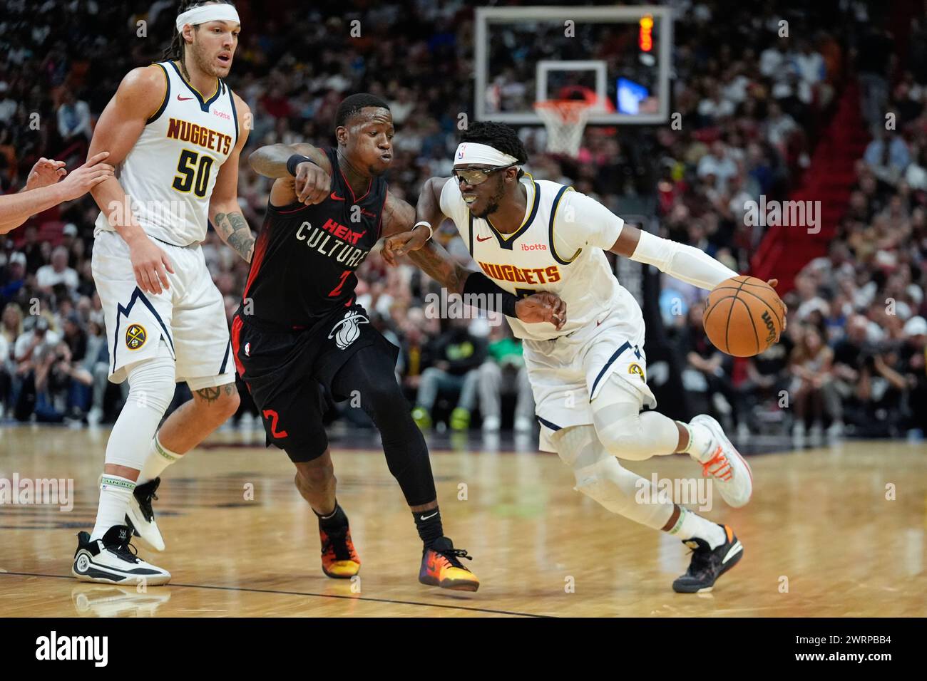 Denver Nuggets guard Reggie Jackson pushes past Miami Heat guard Terry ...