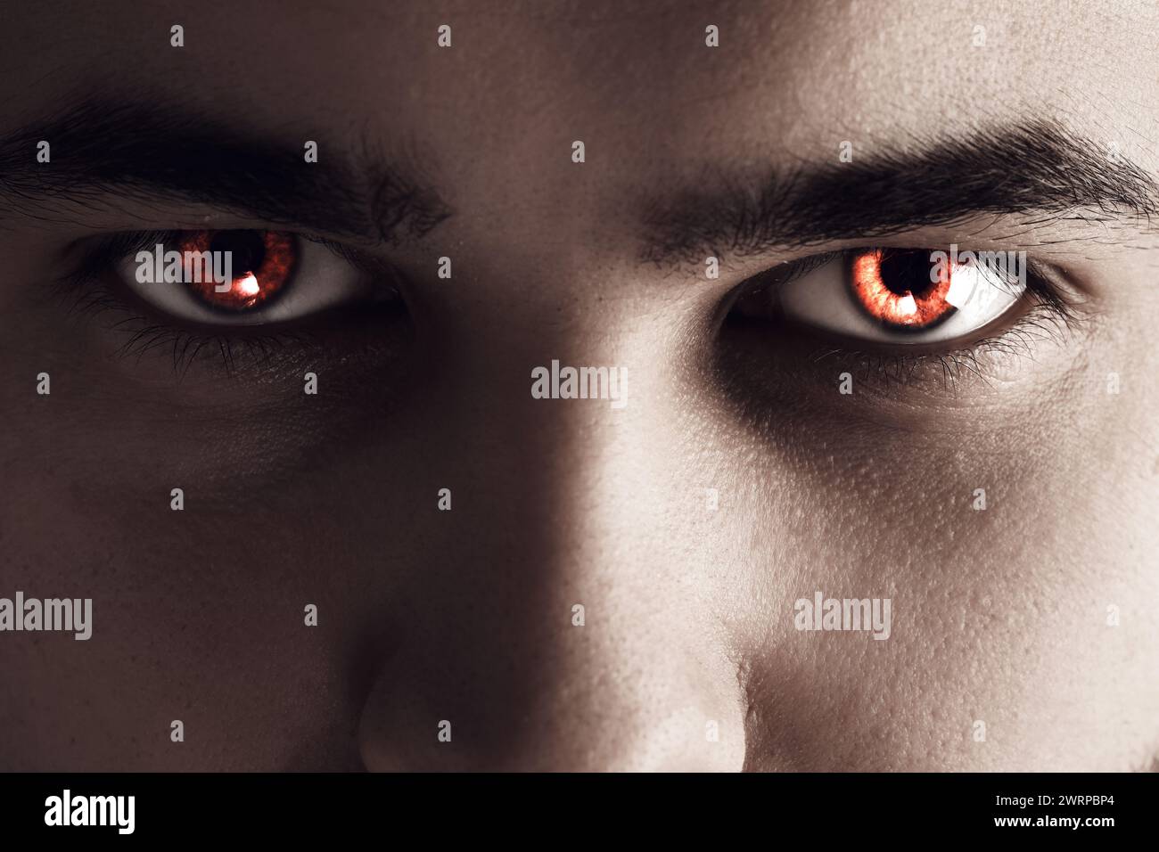 Evil eye. Man with red demonic eyes, closeup Stock Photo - Alamy