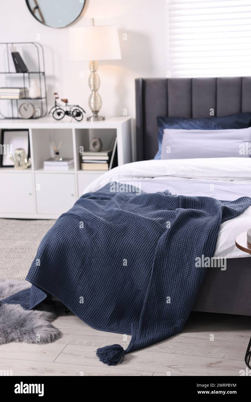 Bright plaid on bed in stylish bedroom. Interior design Stock Photo - Alamy