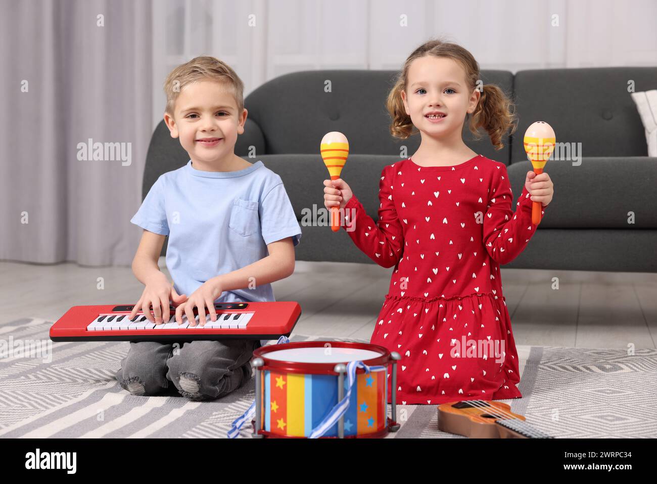 Little children playing toy musical instruments at home Stock Photo - Alamy