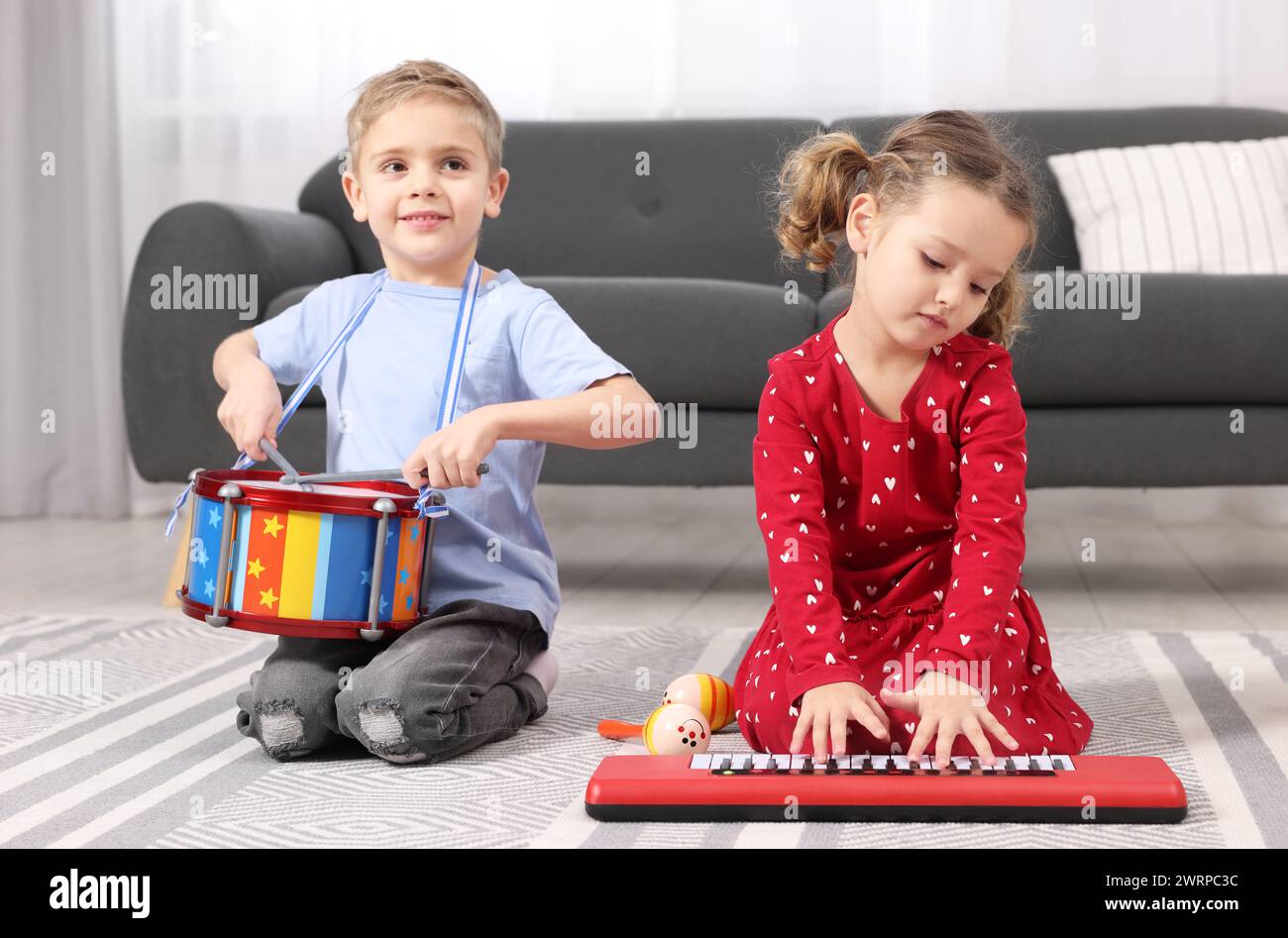 Little children playing toy musical instruments at home Stock Photo - Alamy