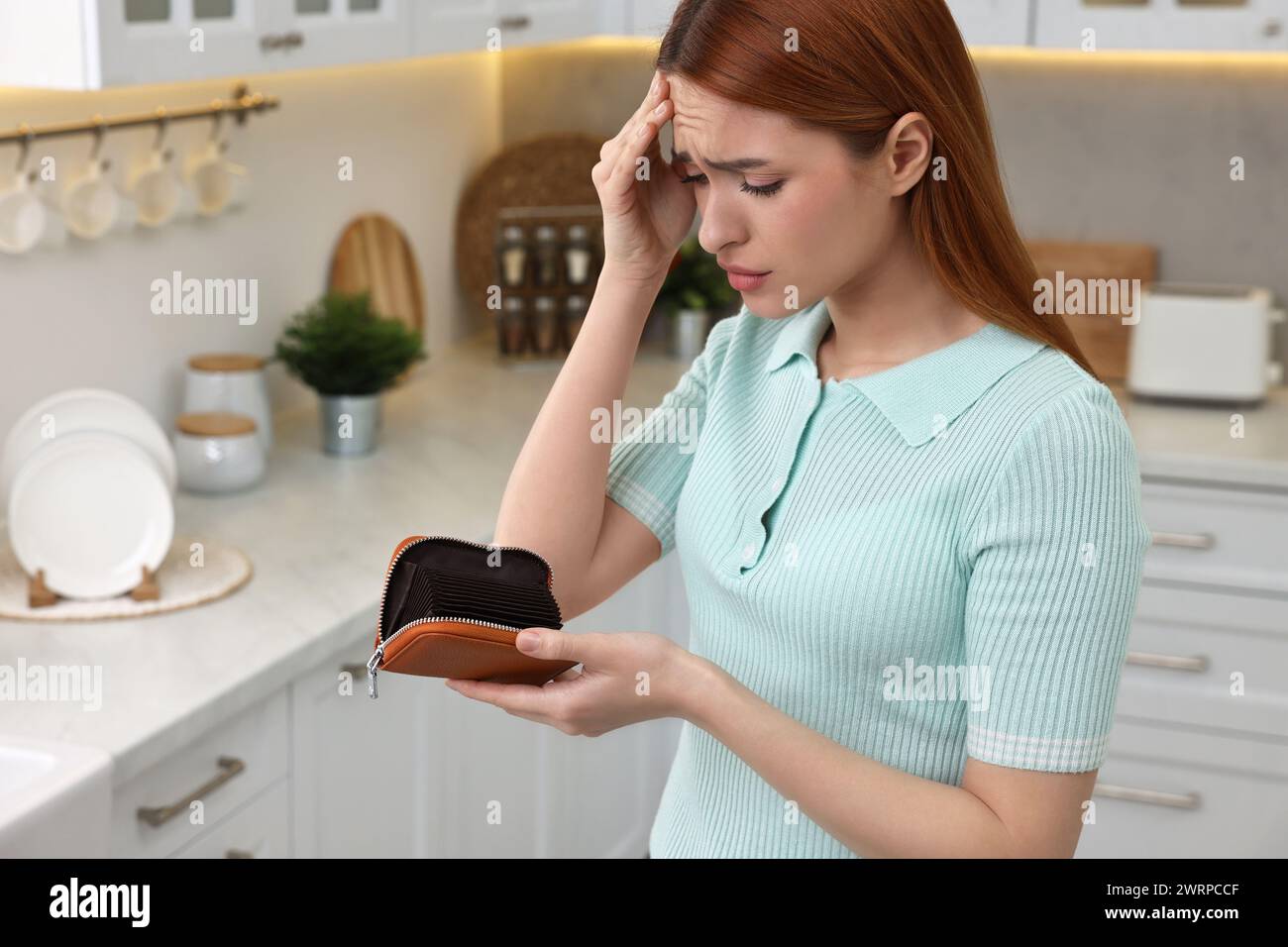 Upset woman with empty wallet at home Stock Photo - Alamy