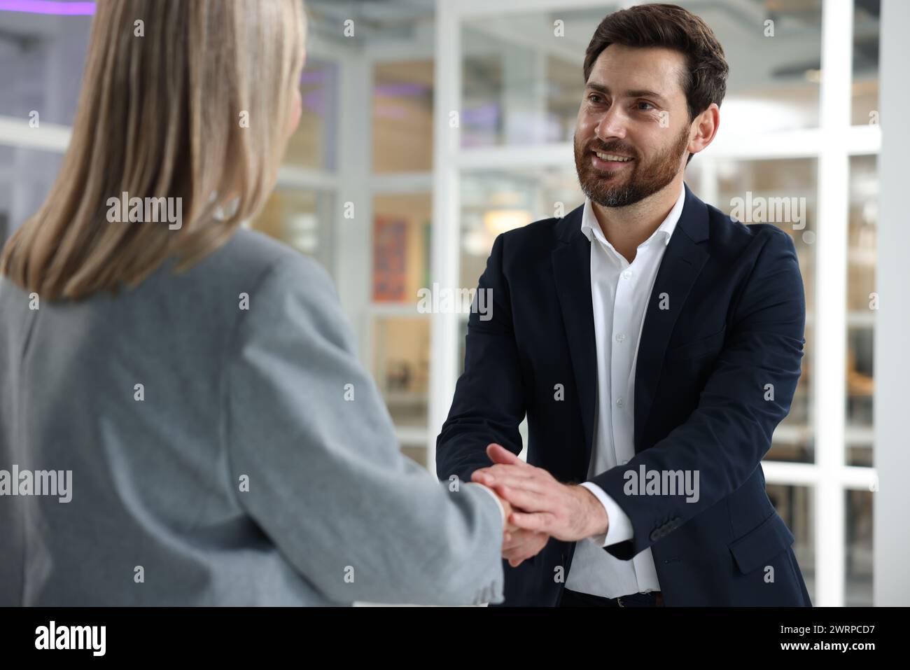 Lawyer shaking hands with client in office Stock Photo - Alamy