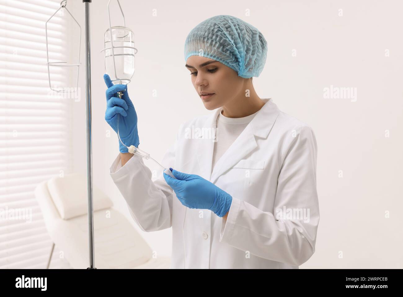 Nurse setting up IV drip in hospital Stock Photo - Alamy