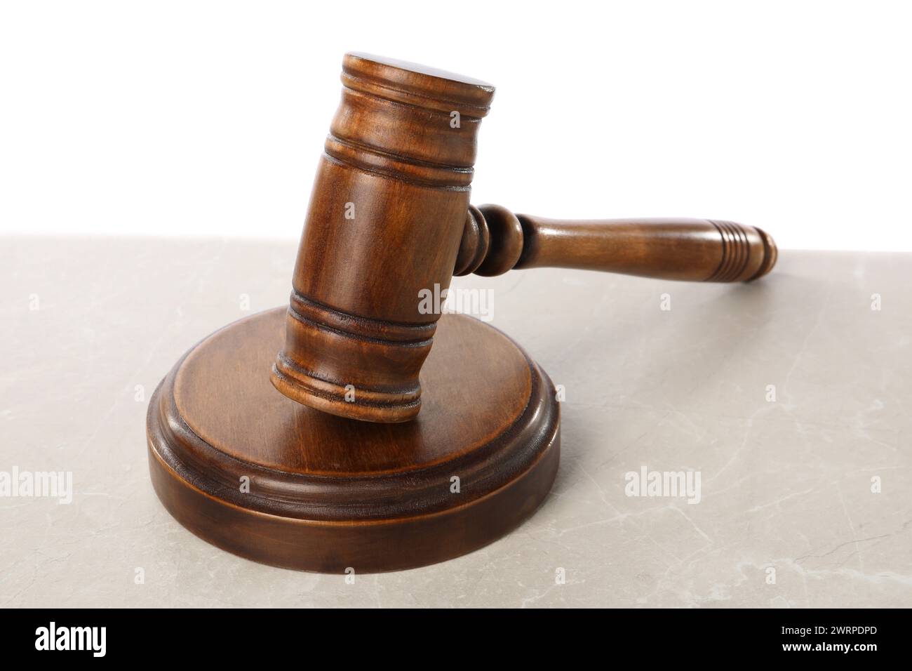 Wooden gavel on light table against white background Stock Photo - Alamy
