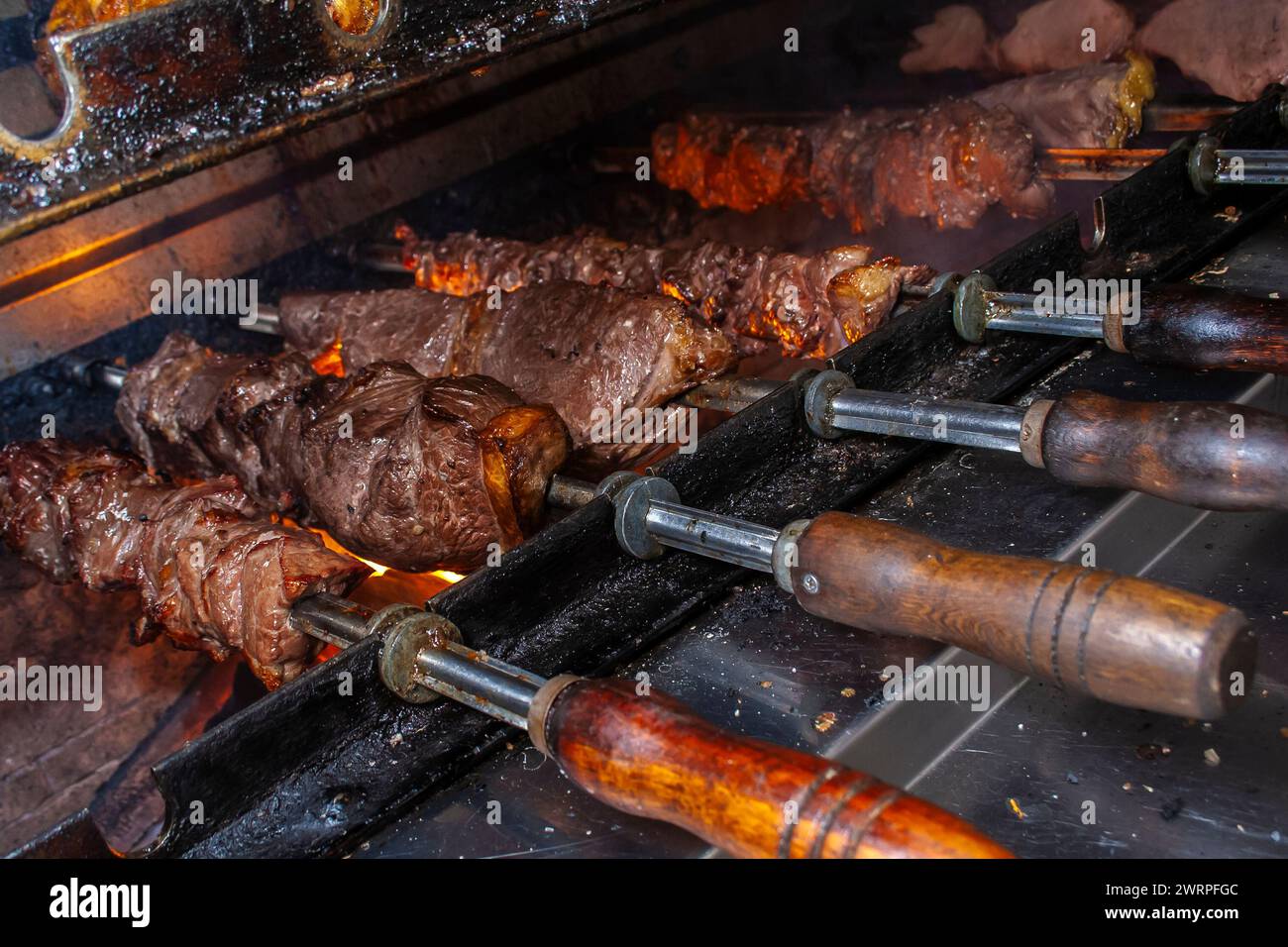 Brazilian style beef ribs Barbecue grill on skewers at a churrascaria ...
