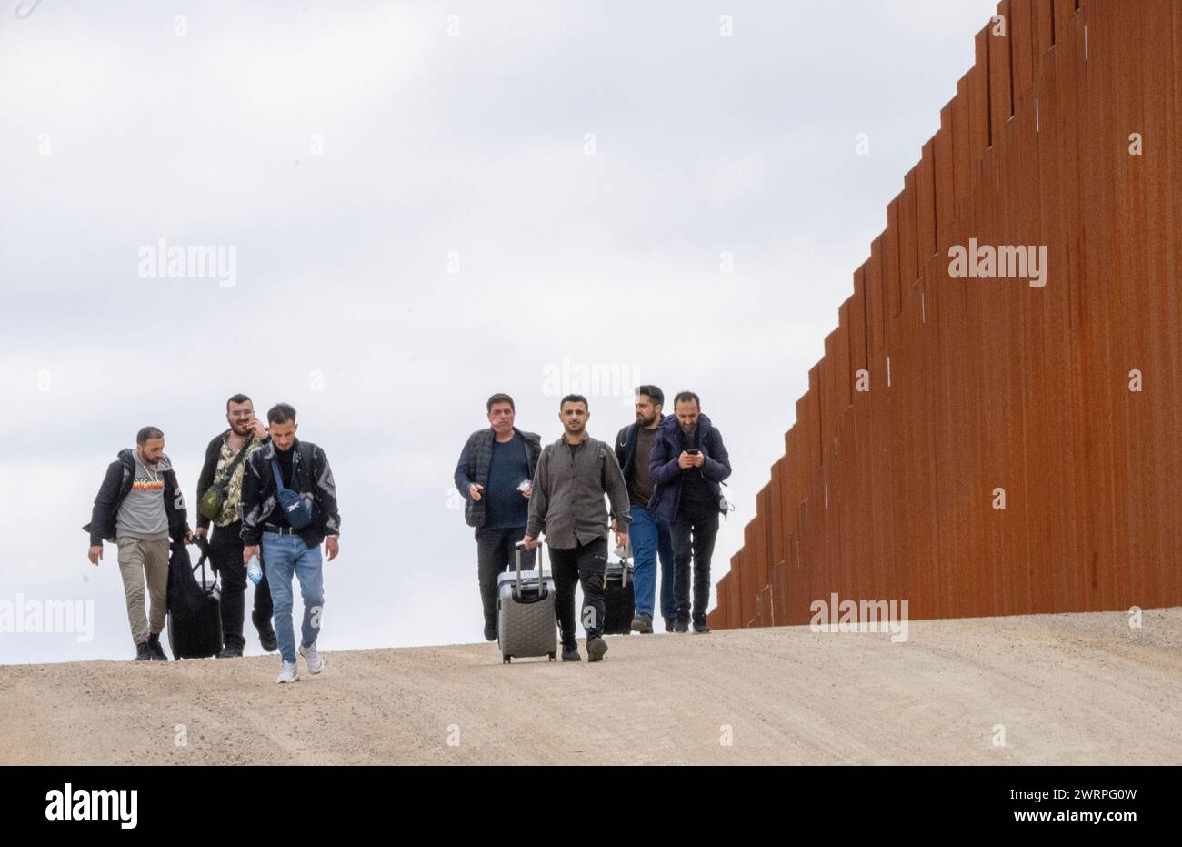 Campo, United States. 13th Mar, 2024. Migrants walk along the United ...