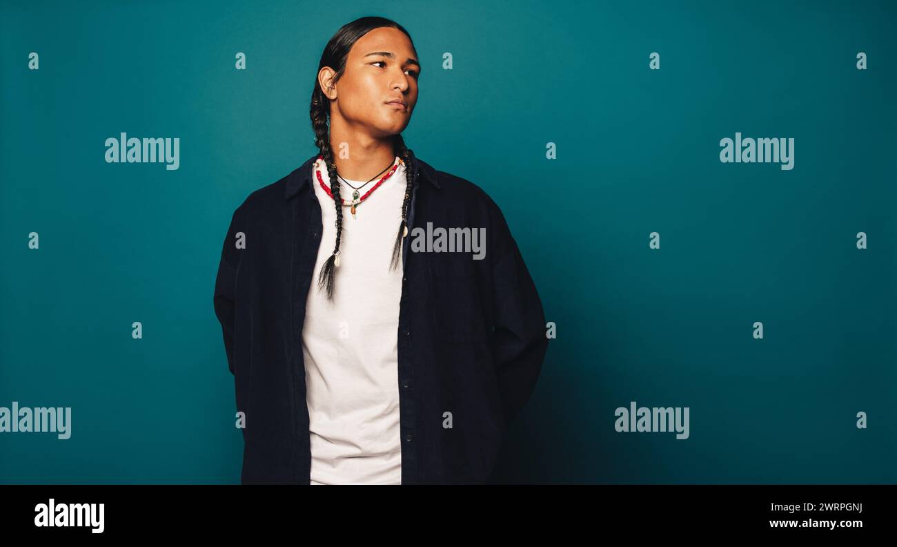 Confident Native American man with braided hair and ethnic necklace ...