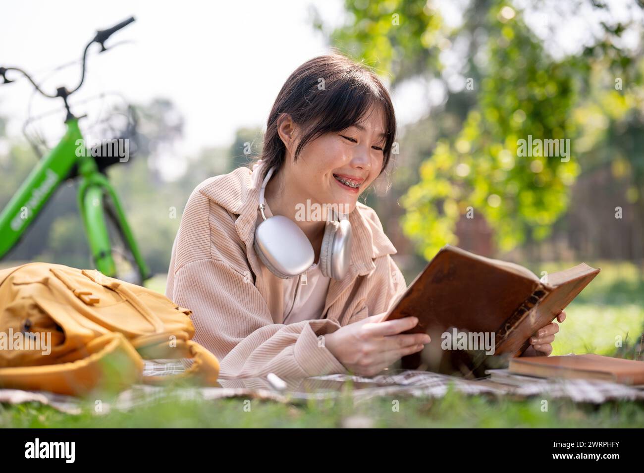 A beautiful and happy young Asian woman is leisurely enjoying her hobby ...