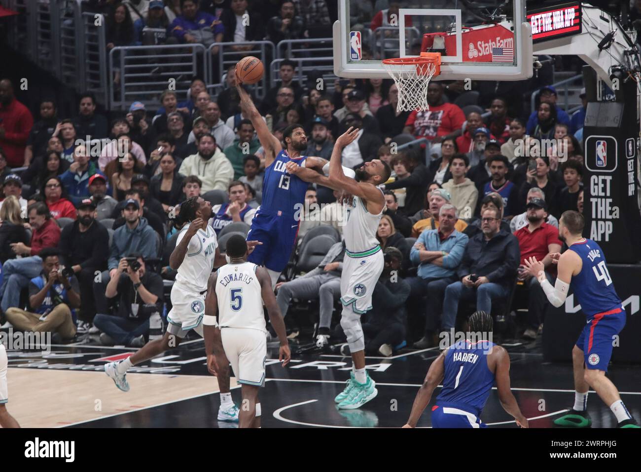 LOS ANGELES, CA - MARCH 12: LA Clippers forward Paul George (13) goes airborne on Minnesota ...