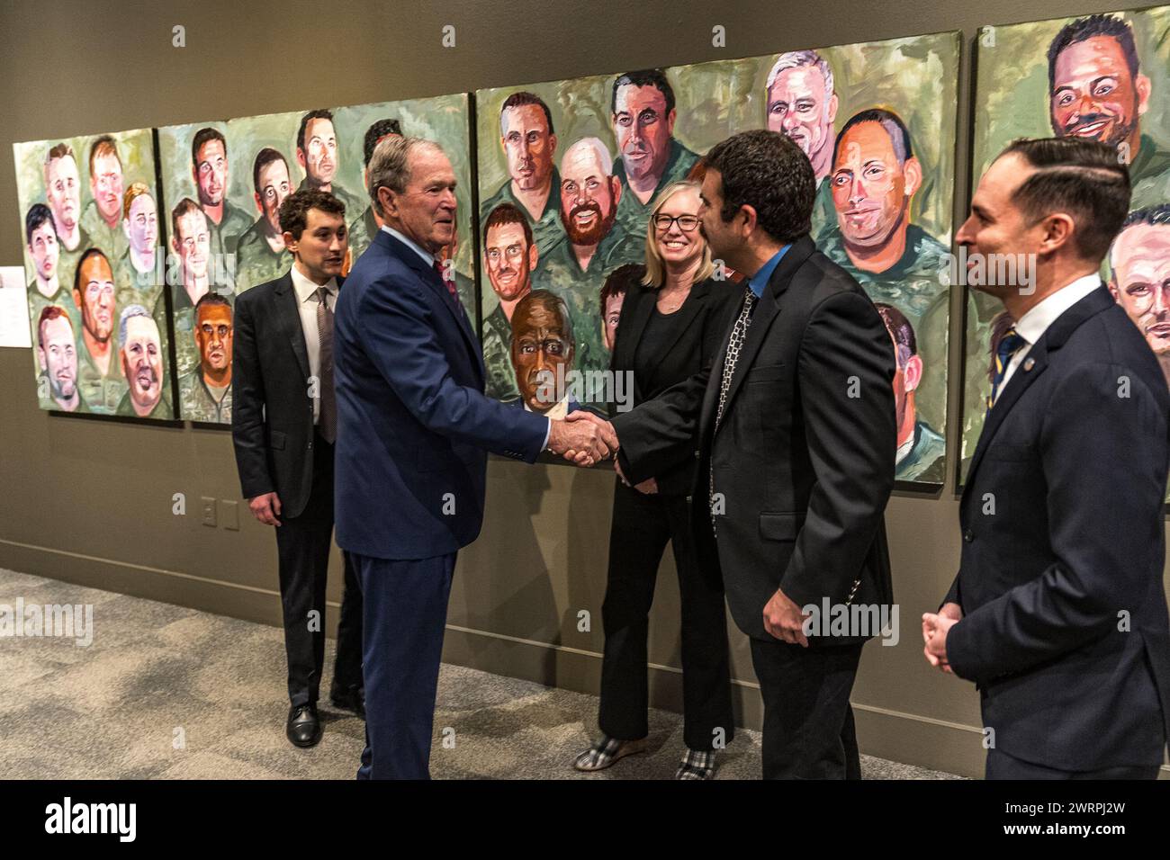 Former President George W. Bush greets curators, Jason Schwartz and ...
