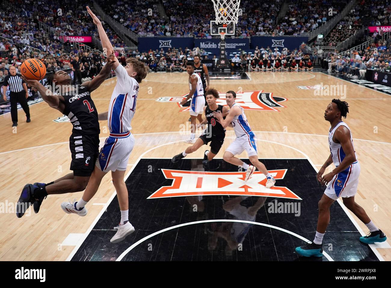Cincinnati guard Jizzle James (2) shoots shoots under pressure from ...