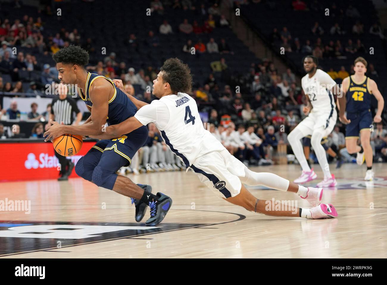 Michigan guard Jace Howard, left, and Penn State forward Puff Johnson ...
