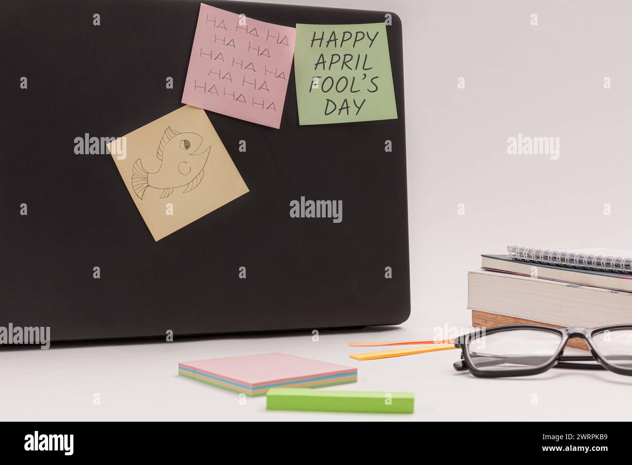 Concept of office on April Fool's Day stationery, laptop, sticky notes ...
