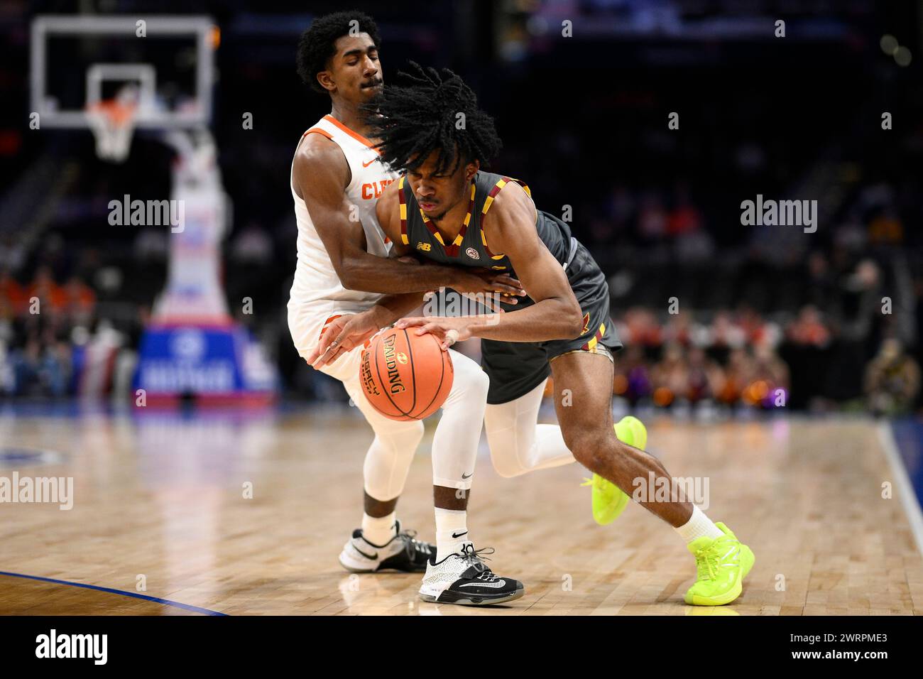 Boston College guard Donald Hand Jr. (13) runs up against Clemson guard ...