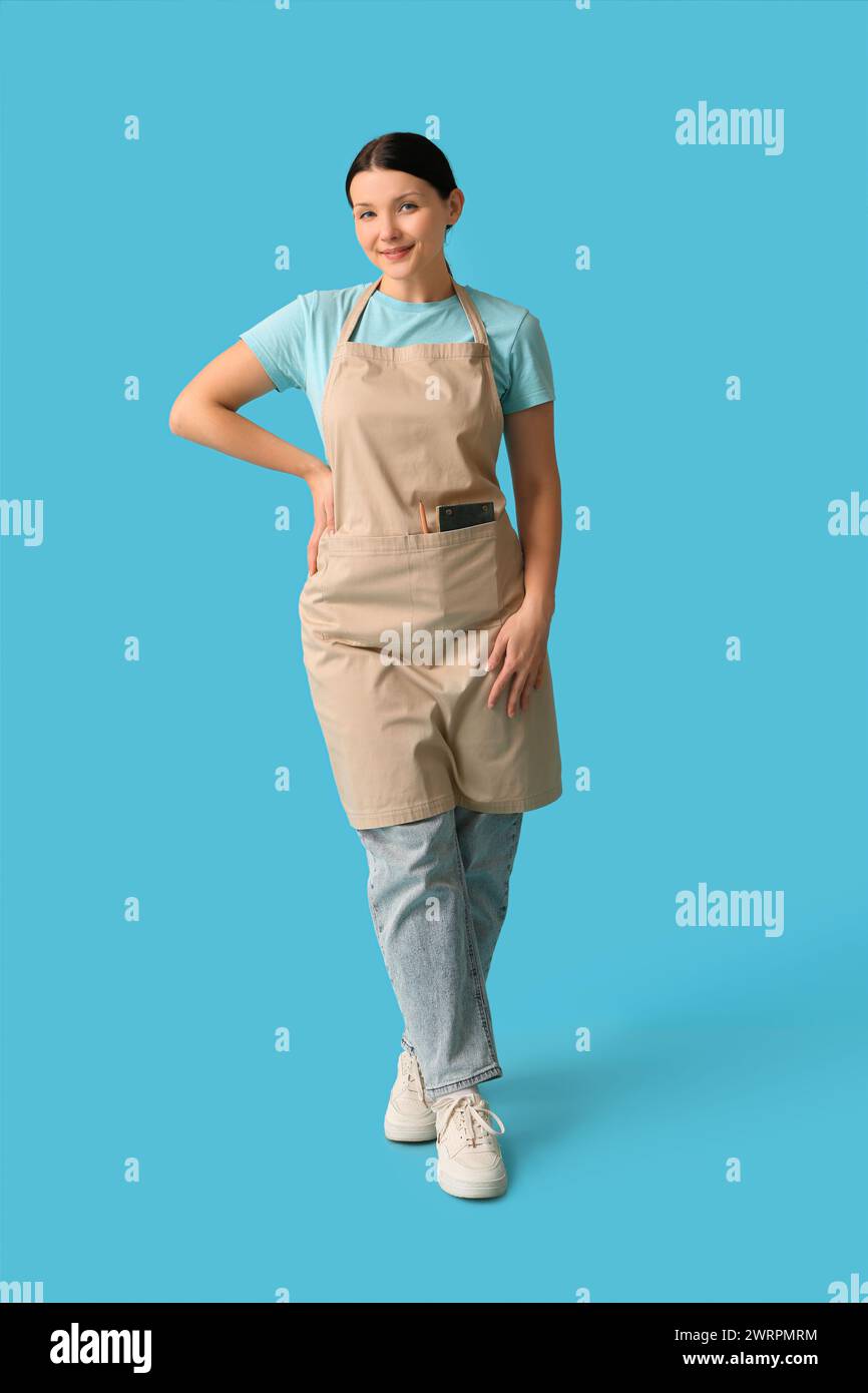 Beautiful young waitress on blue background Stock Photo - Alamy