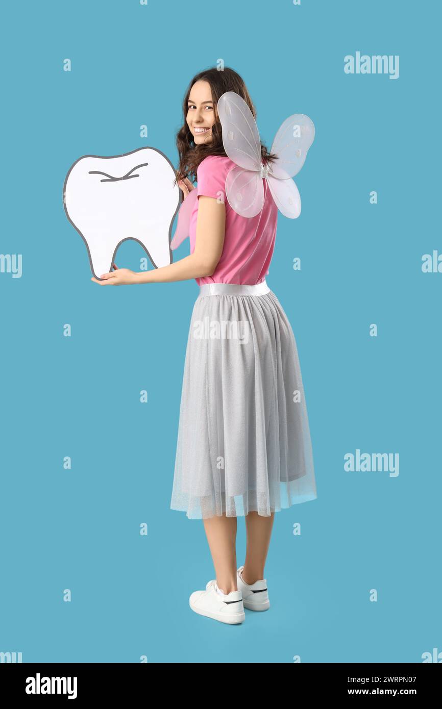 Tooth Fairy with paper figure on blue background Stock Photo - Alamy
