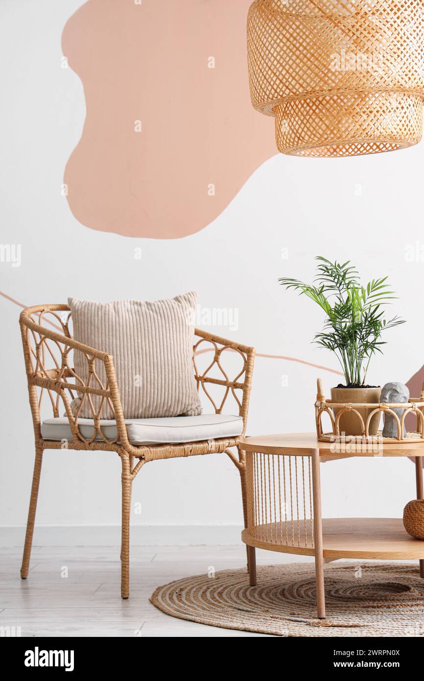 Interior of living room with armchair, cushion and coffee table near ...
