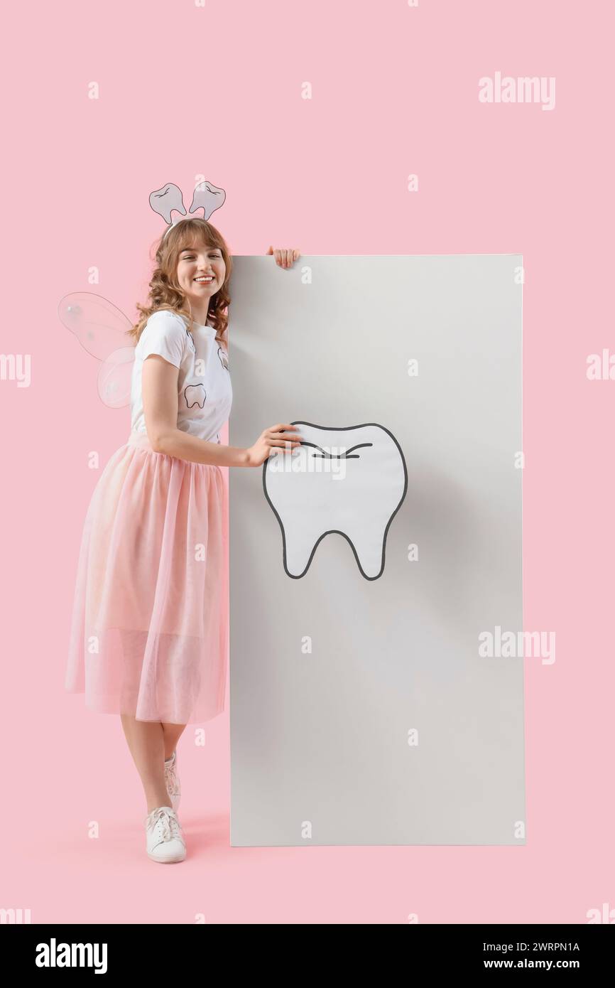 Tooth Fairy with paper figure and blank poster on pink background Stock ...