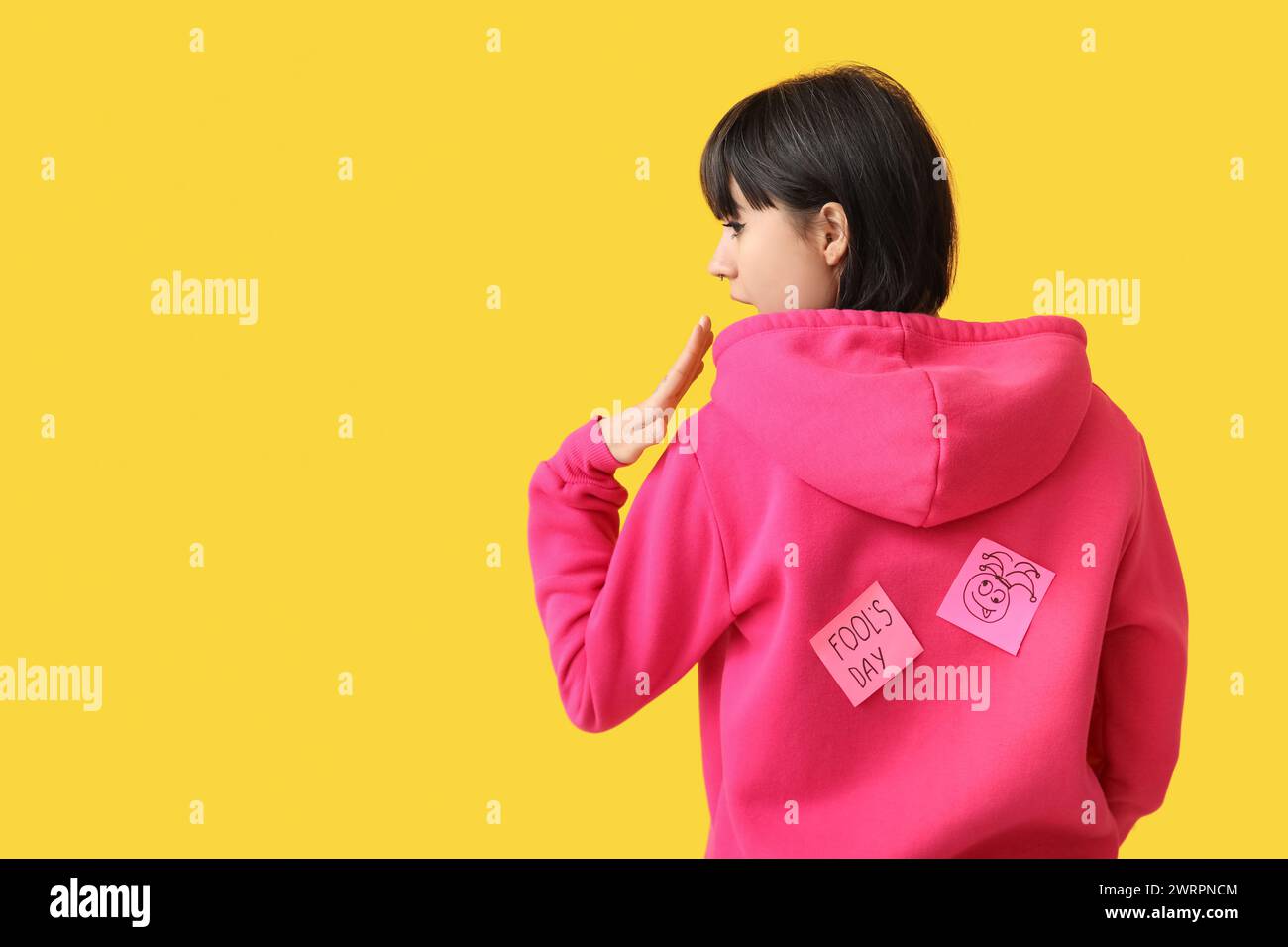 Beautiful young shocked woman with stickers attached to her back on ...