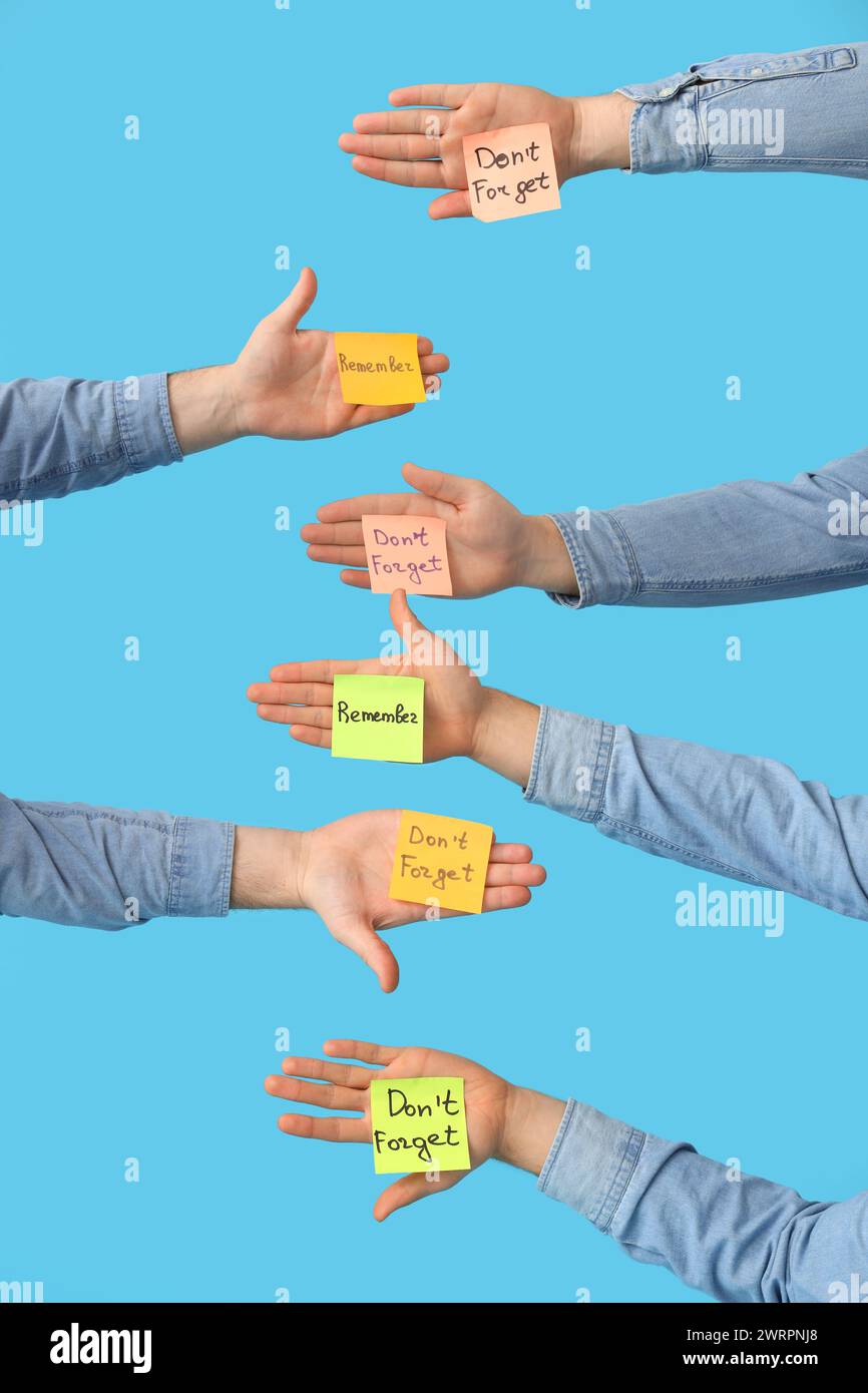 Men with reminders on blue background Stock Photo - Alamy