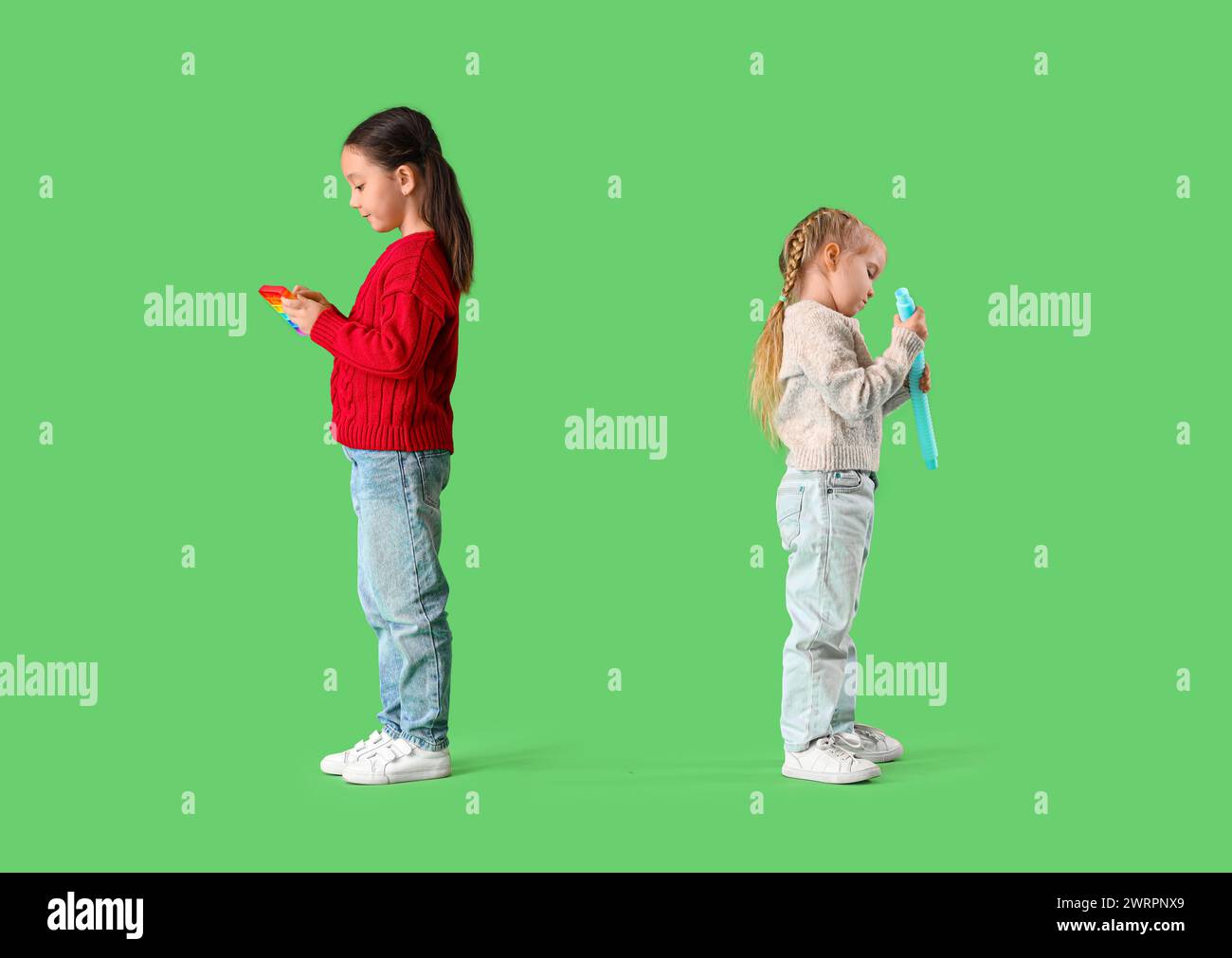 Little girls with autistic disorder and toys on green background Stock ...