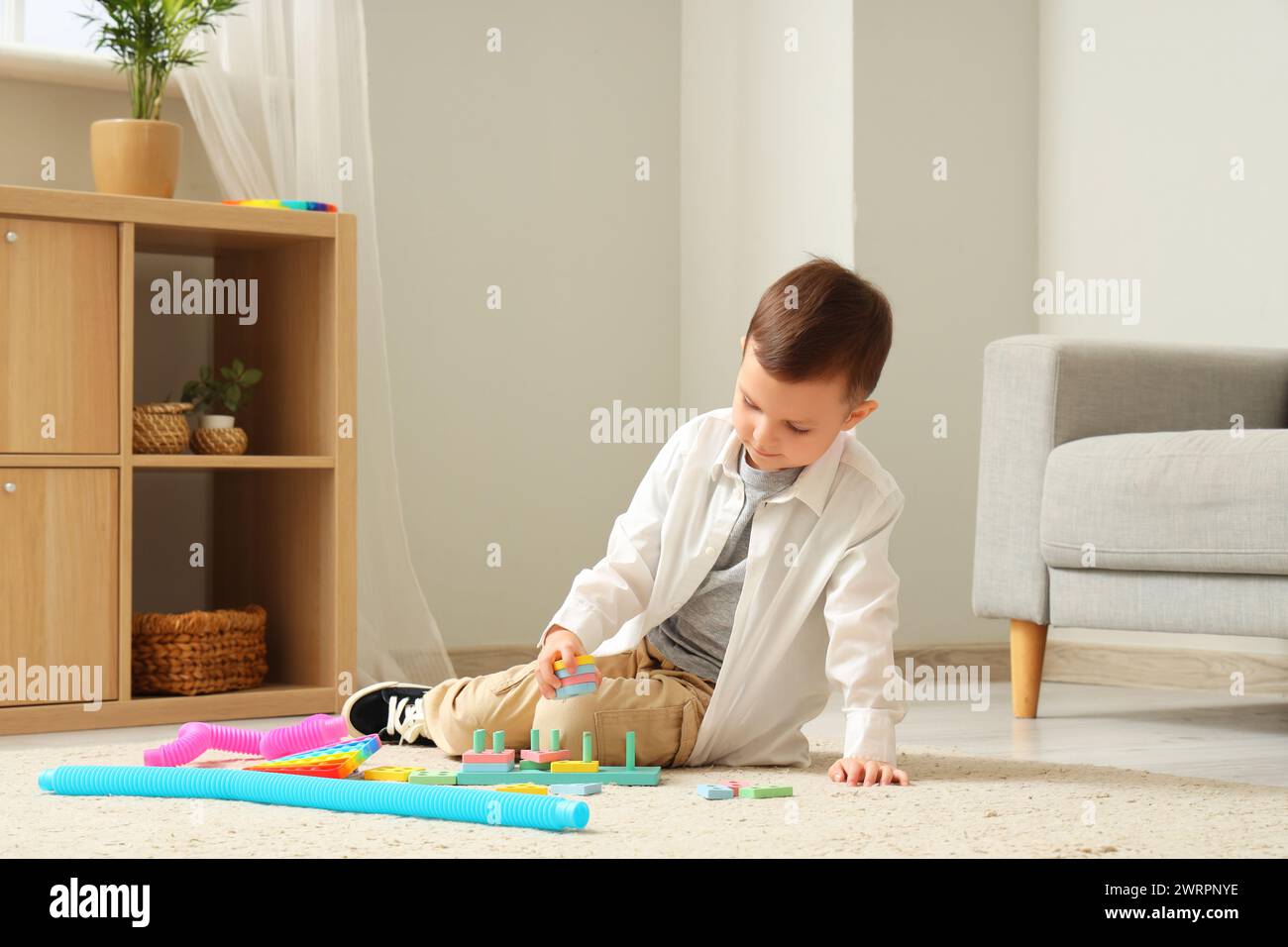 Little boy with autistic disorder playing at home Stock Photo - Alamy