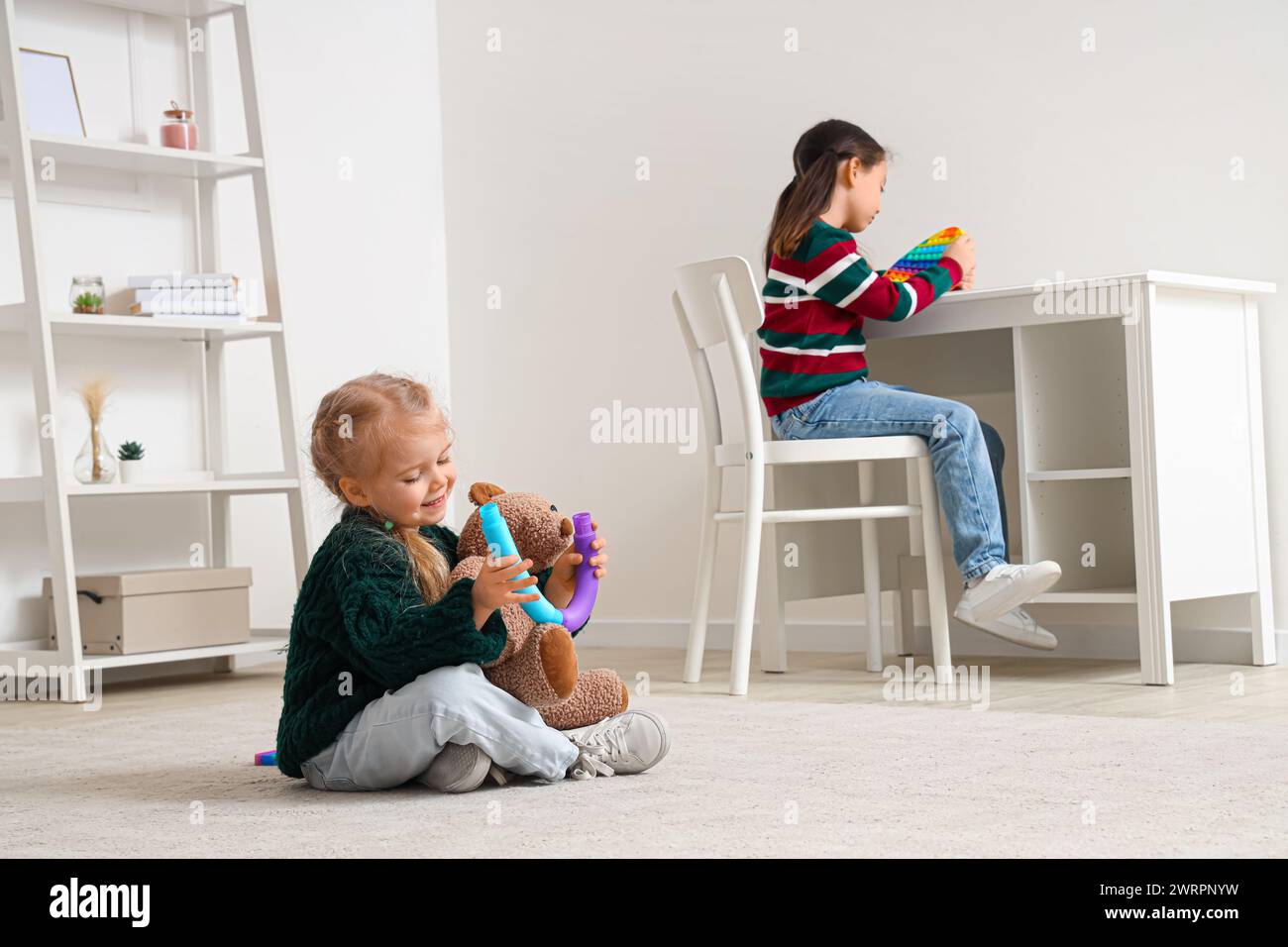 Autistic child playing toys hi-res stock photography and images - Alamy