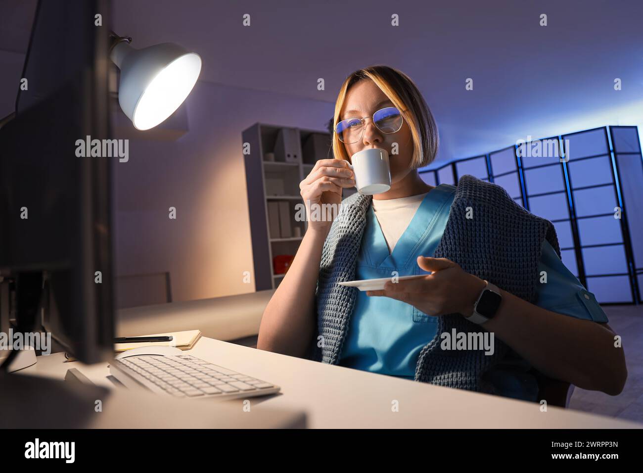 Female nurse drinking coffee hi-res stock photography and images - Alamy