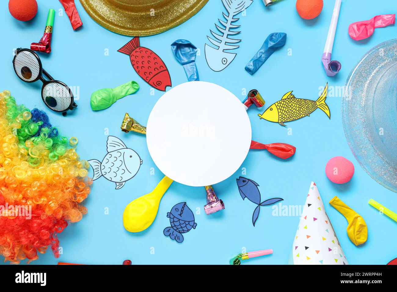 Blank card with paper fishes and party decor on blue background. April ...