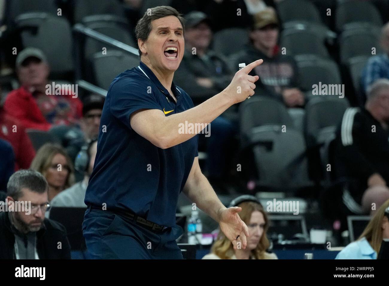 California head coach Mark Madsen motions towards the court during the ...
