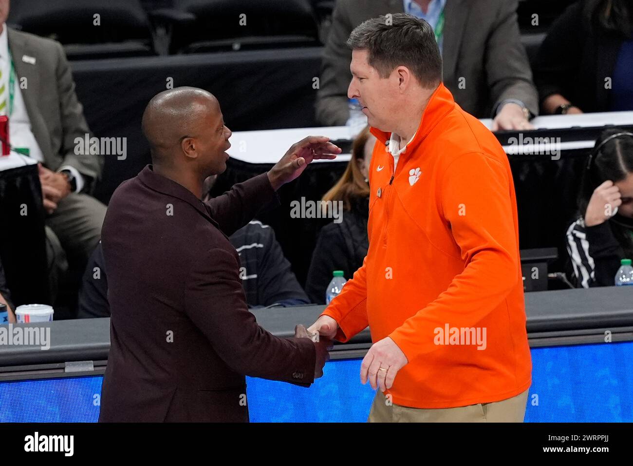 Clemson head coach Brad Brownell, right, congratulating Boston College ...