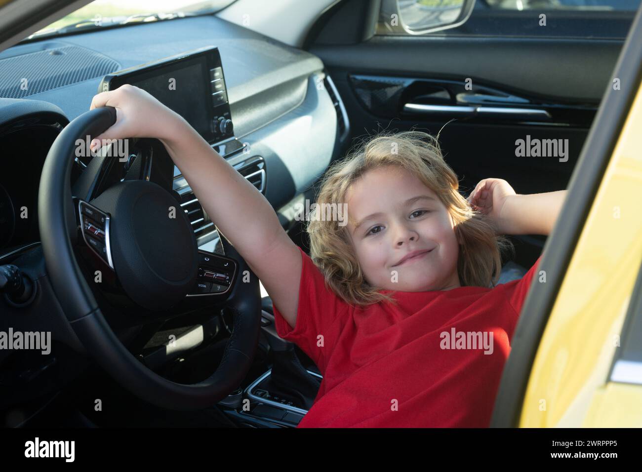 Little Driver. Cute little boy pretending to drive. Kid in car with his ...