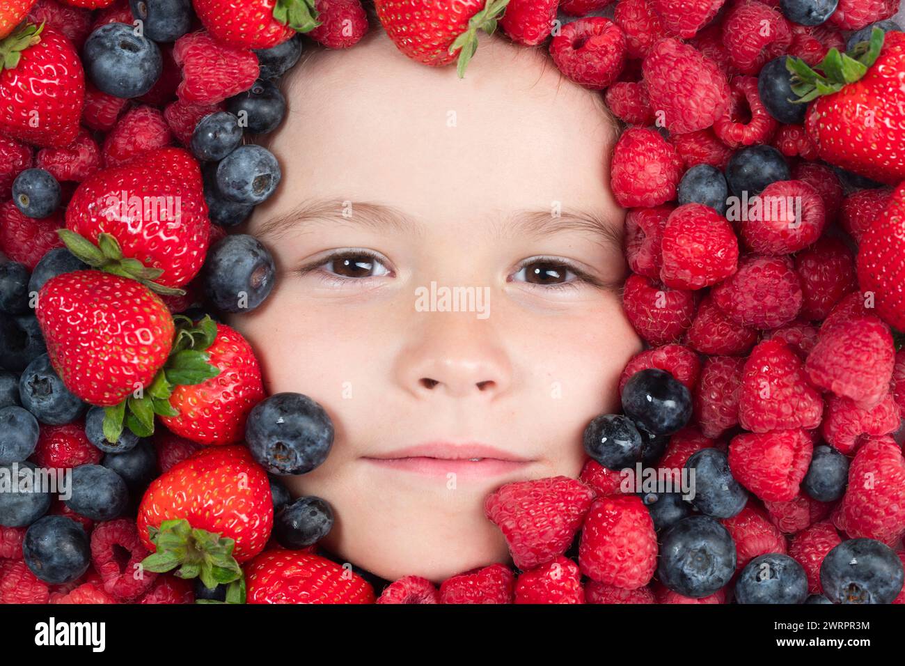 Funny fruits. Berries mix blueberry, raspberry, strawberry, blackberry ...