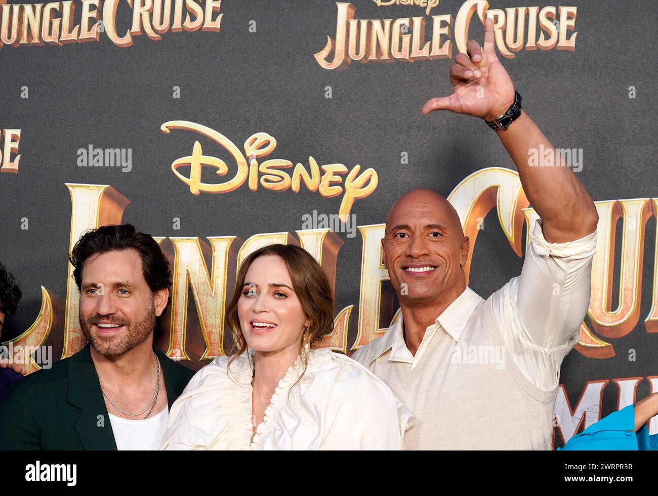 FILE - Dwayne Johnson, right, a cast member in "Jungle Cruise," flashes ...