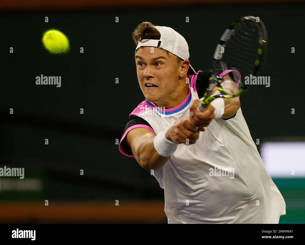 March 13, 2024 Holger Rune of Denmark returns a shot against Taylor ...