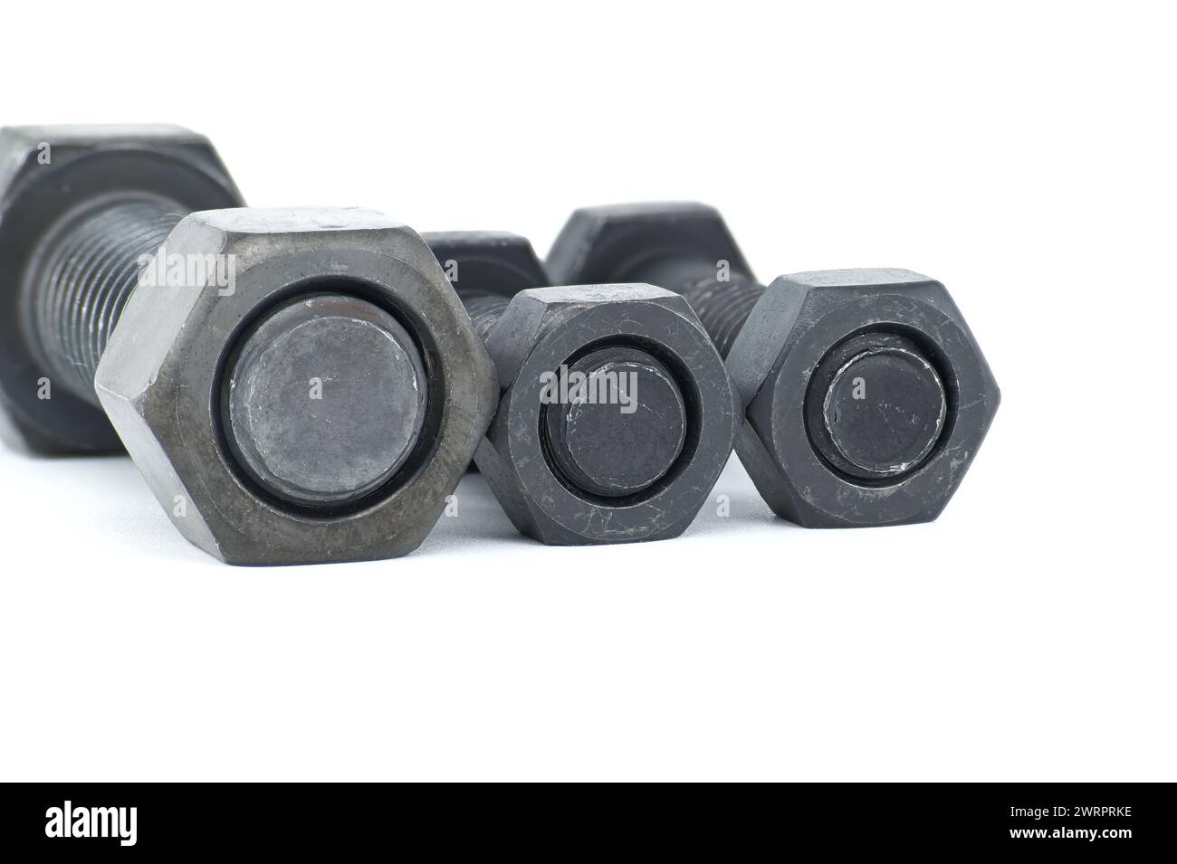 Black metal hexagonal bolts and nuts shown in close-up isolated on ...