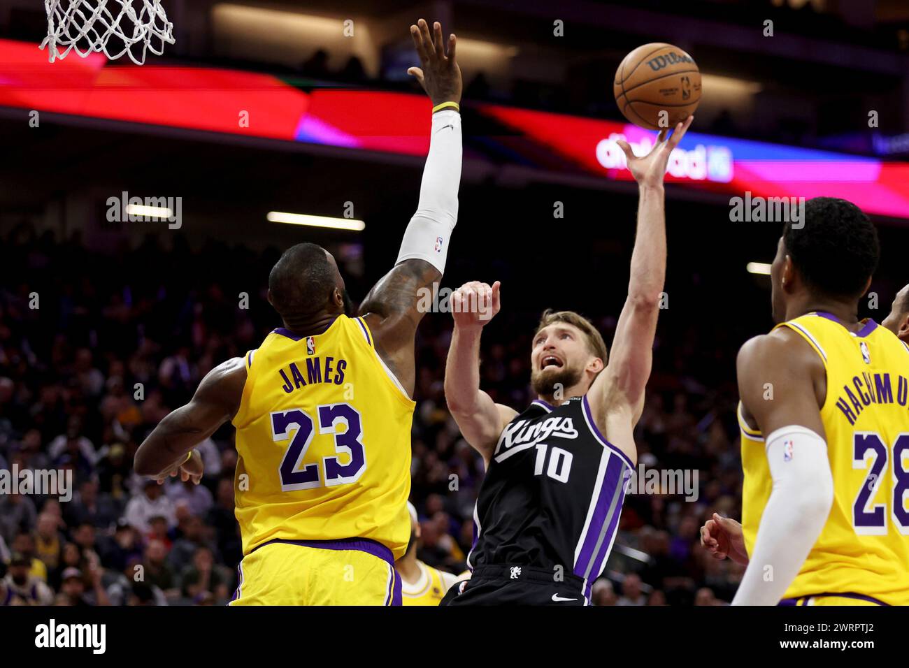 Sacramento Kings forward Domantas Sabonis (10) shoots against Los Angeles Lakers forward LeBron ...