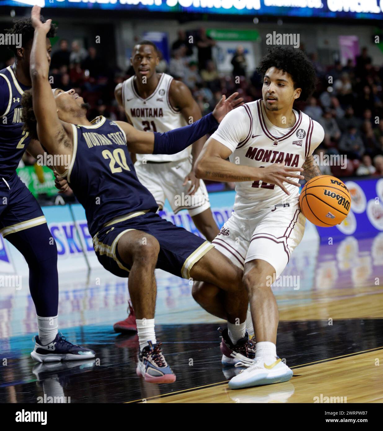 Montana guard Brandon Whitney (12) drives to the basket and draws ...