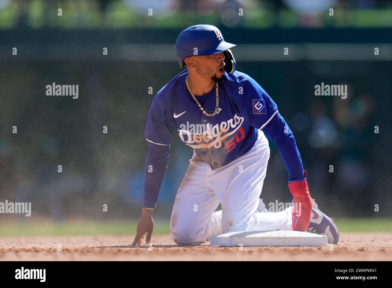 Los Angeles Dodgers' Mookie Betts pauses at second base after being ...