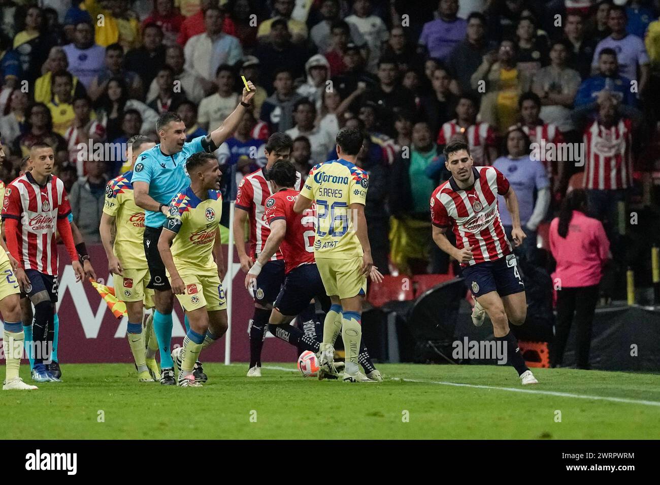Guadalajara's Antonio Briseno, rignt, is shown a yellow card by referee ...