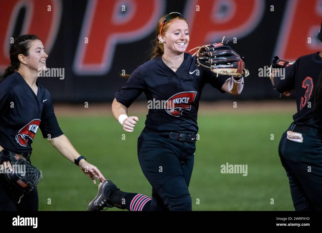 WKU left fielder Kelsey Schmidt, middle, celebrates with center fielder ...