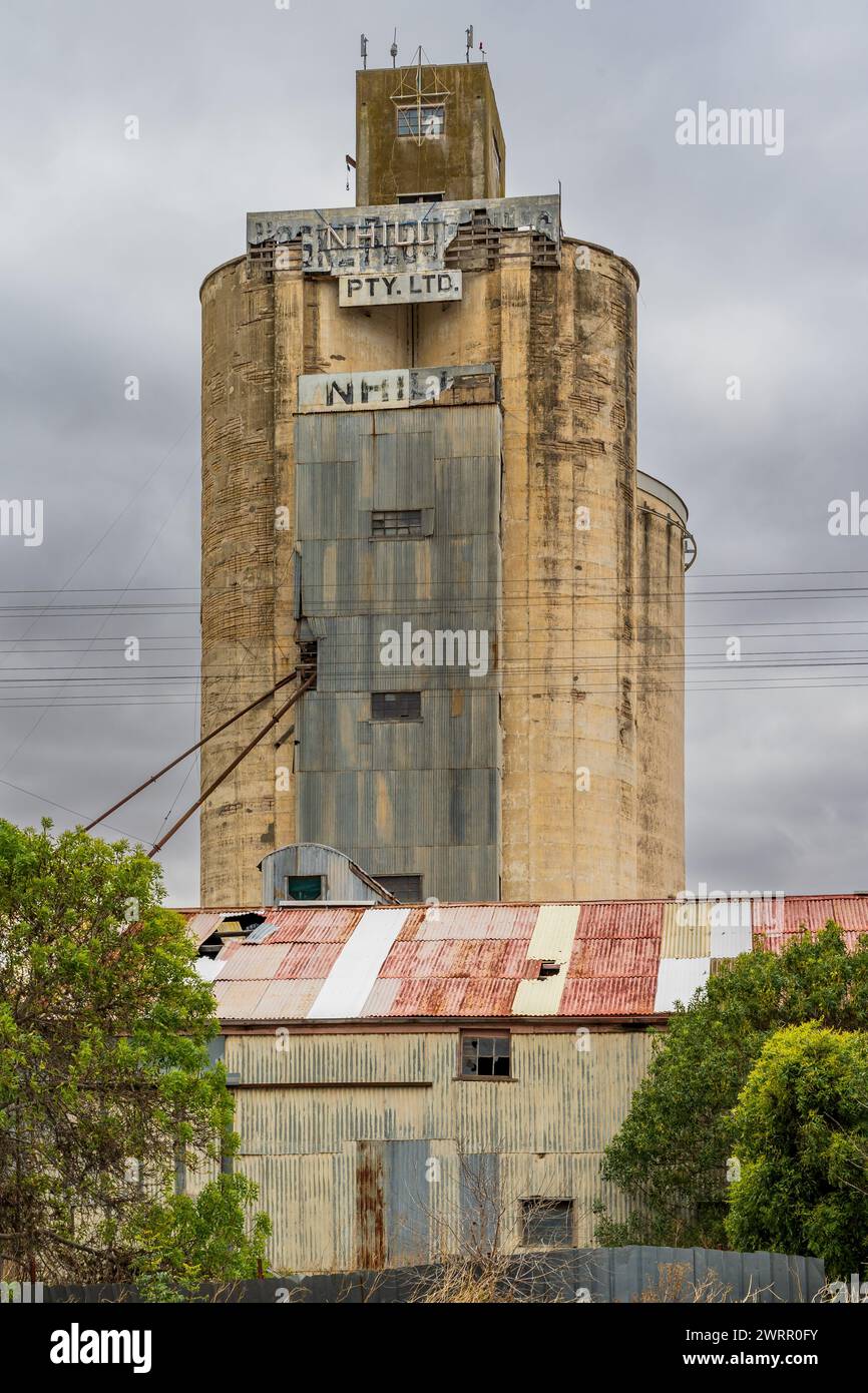 Tall concrete grain silos and storage sheds in a rural town at Nhill in Western Victoria ...